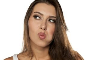 Tongue pressed against cheek body language - PsychMechanics